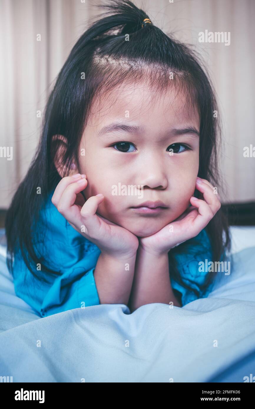 Illness asian child on sickbed and looking at camera, admitted in ...