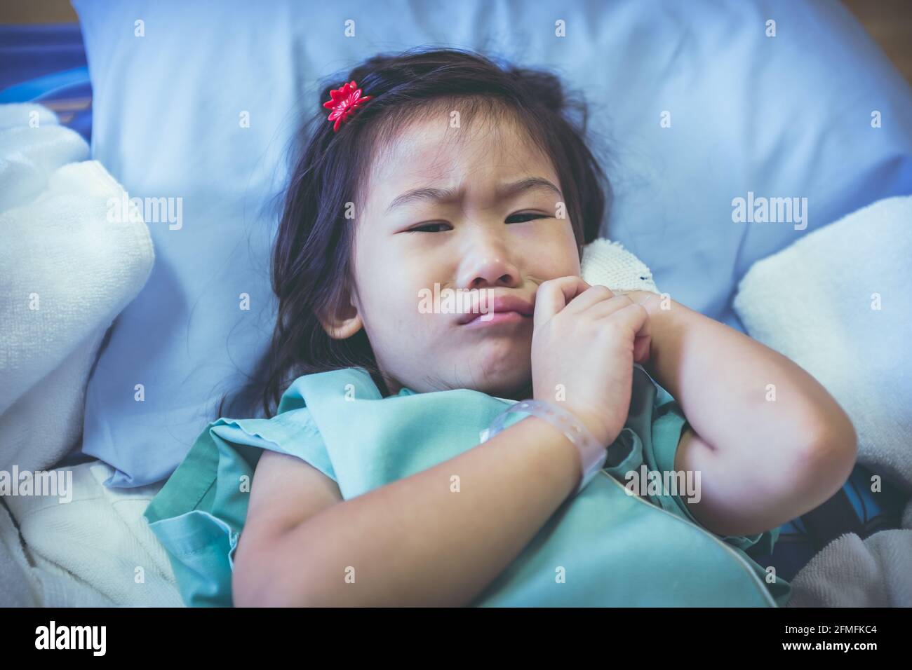 Illness asian child looking at camera, admitted in hospital with saline ...