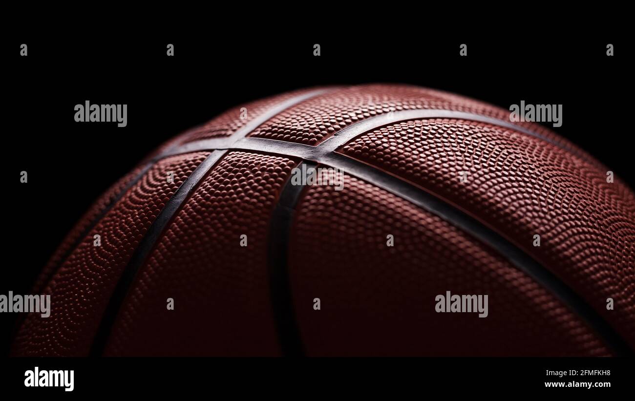 Backlit back of a basketball ball on a black background. Horizontal ...