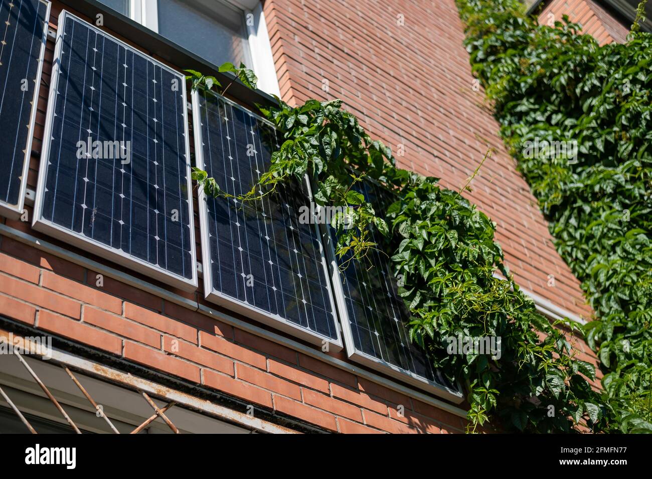 Close-up of solar panels on a red brick wall. Alternative energy source ...