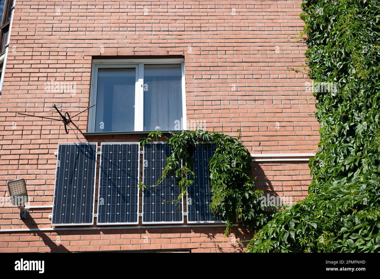 Close-up of solar panels on a red brick wall. Alternative energy source ...