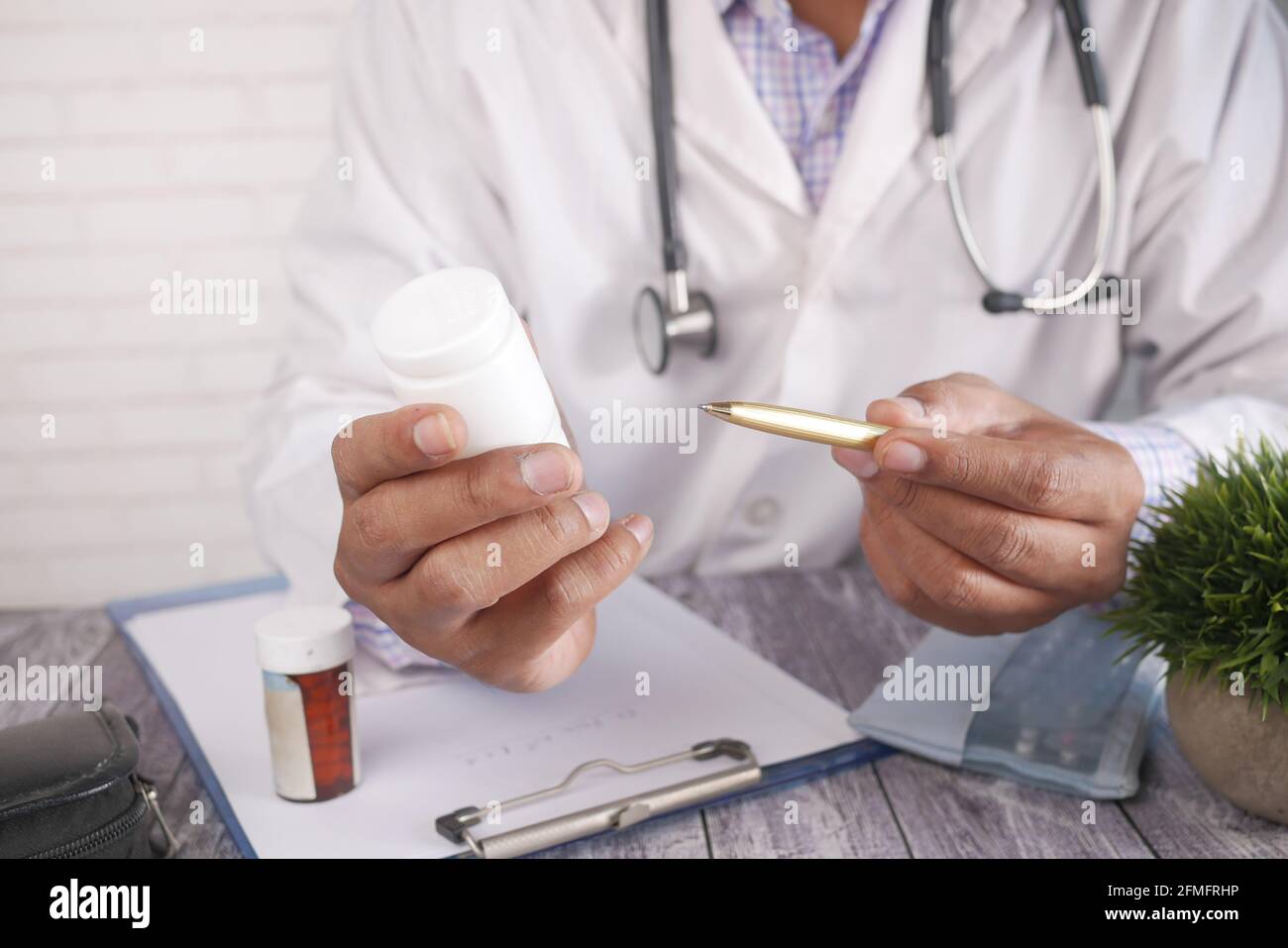 Doctor hand holding pill container hi-res stock photography and images ...