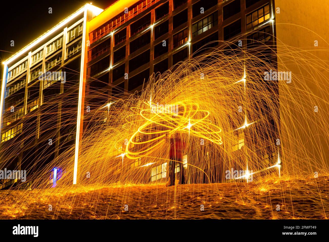 Large round burning fireworks sparkle from the burning steel wool. The ...