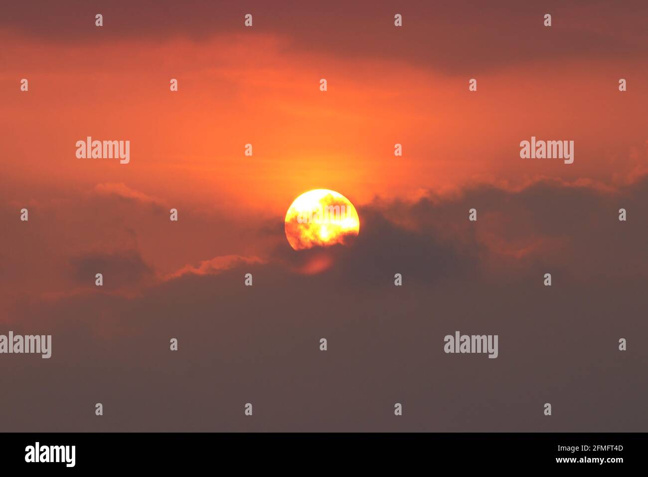big bright sun on red and yellow sky background Stock Photo - Alamy