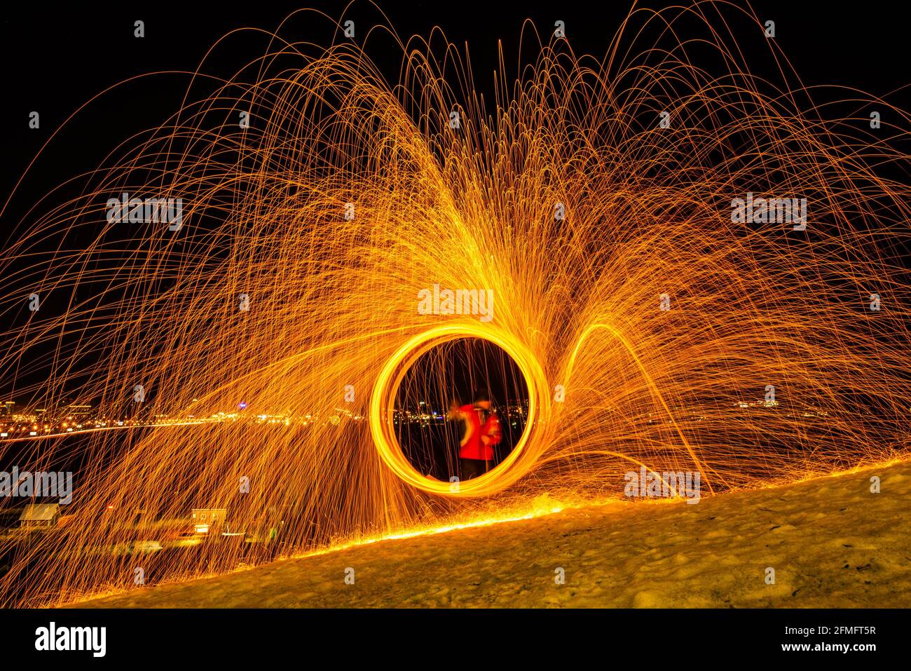 Large round burning fireworks sparkle from the burning steel wool. The ...