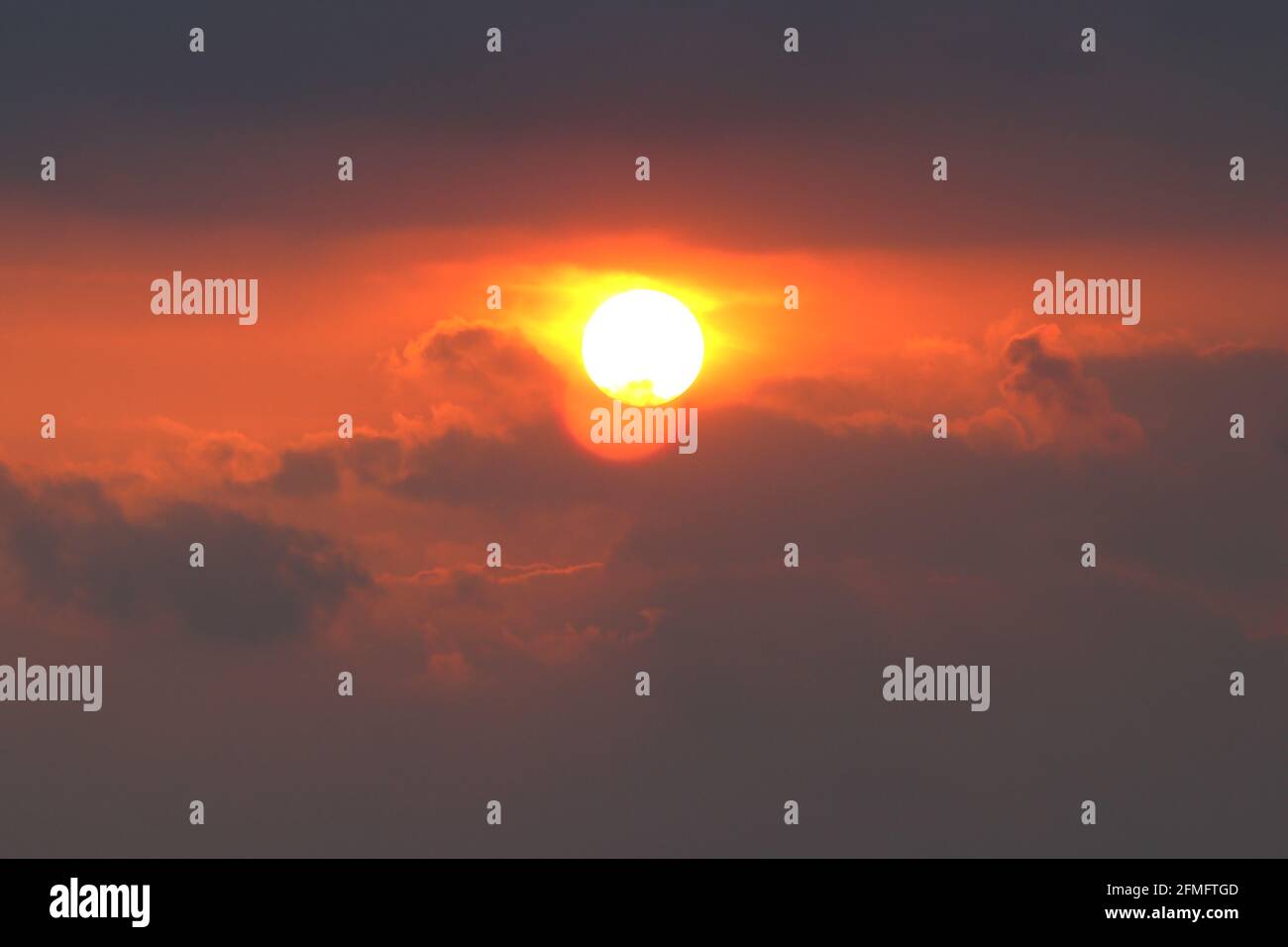 big bright sun on red and yellow sky background Stock Photo - Alamy