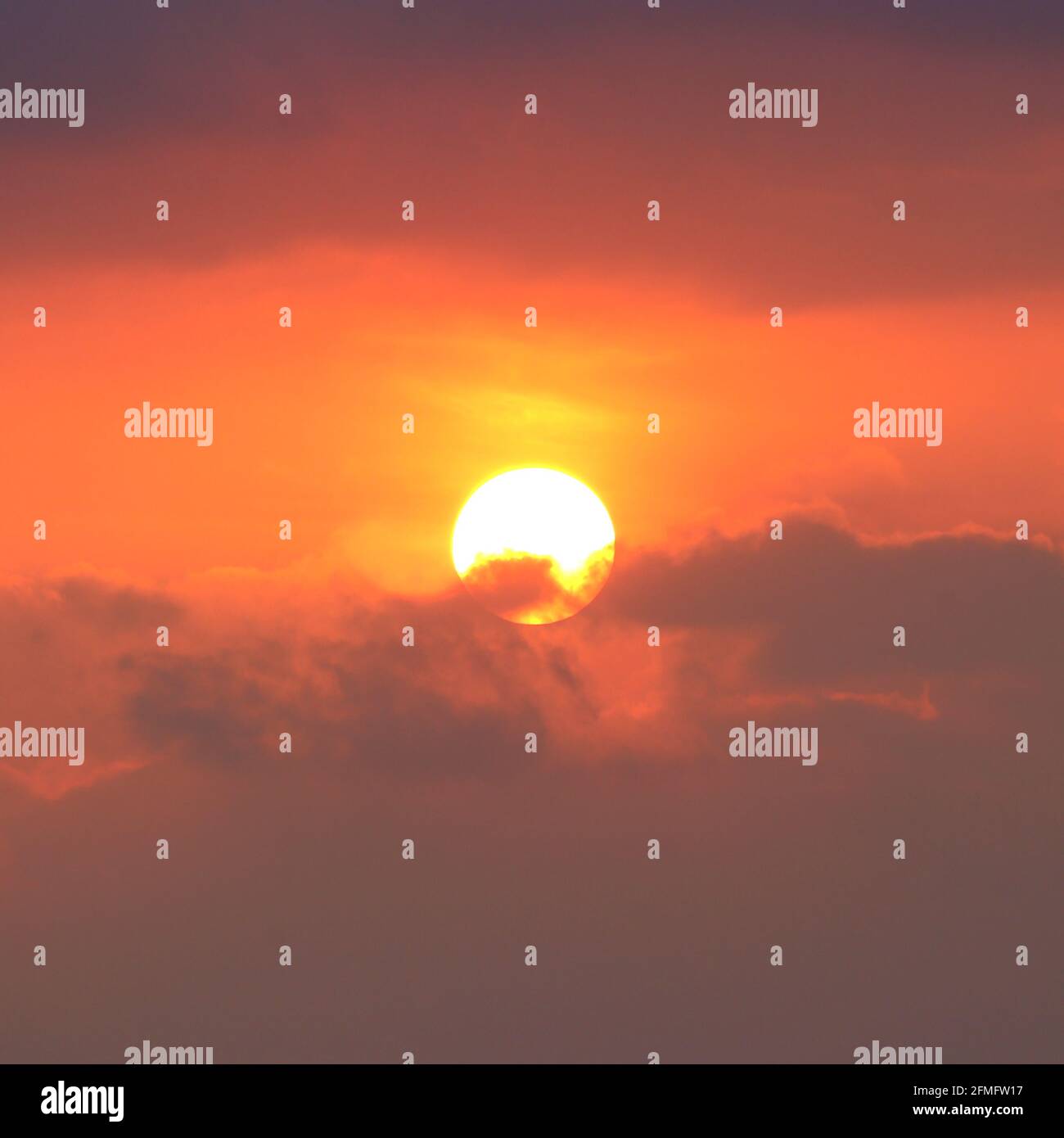 big bright sun on red and yellow sky background Stock Photo - Alamy