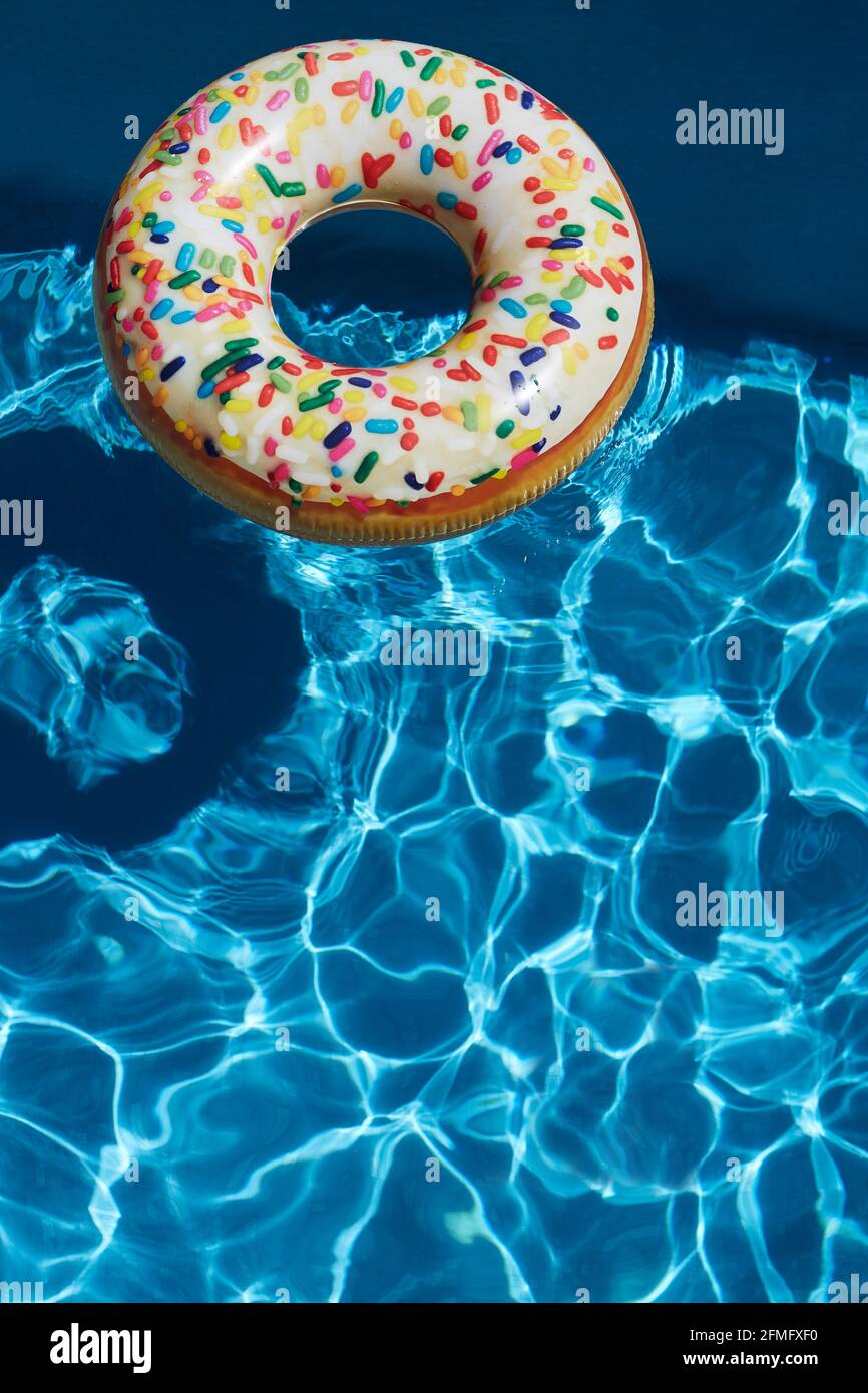 Inflatable donut ring in blue swimming pool Stock Photo - Alamy