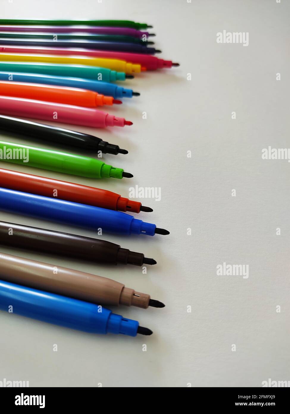 A group of colorful markers without caps isolated on a white background ...