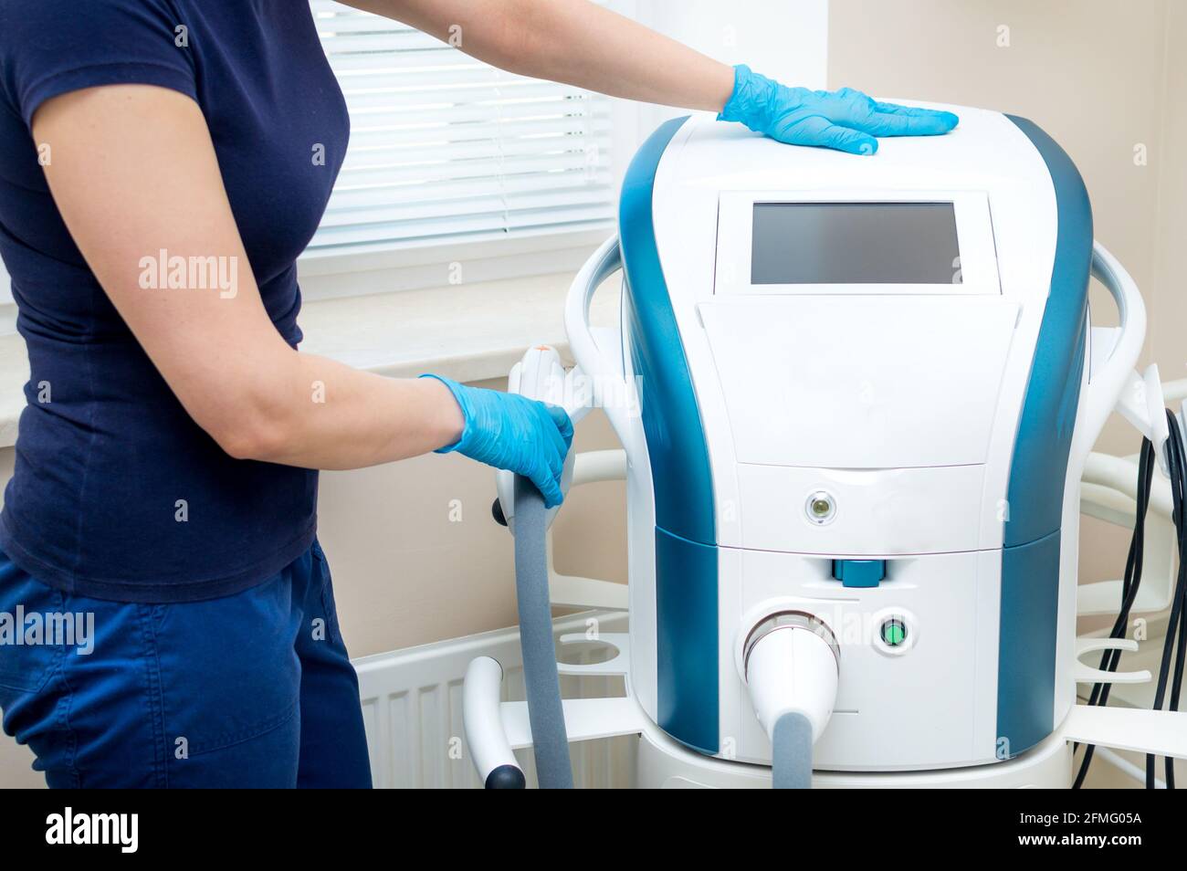 doctor stands at the laser apparatus. Hardware cosmetology Stock Photo ...