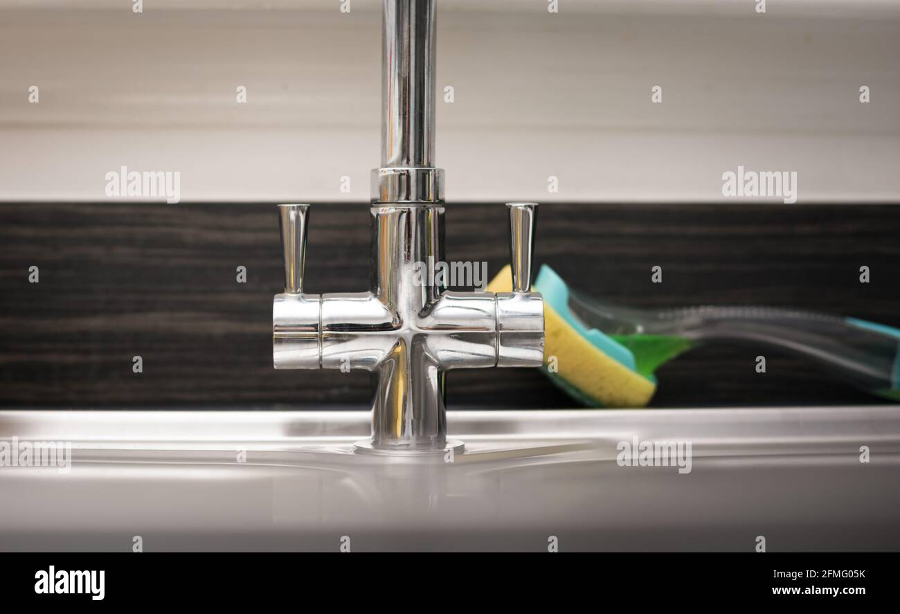 Kitchen tap isolated on bright background. Water saving solutions Stock ...