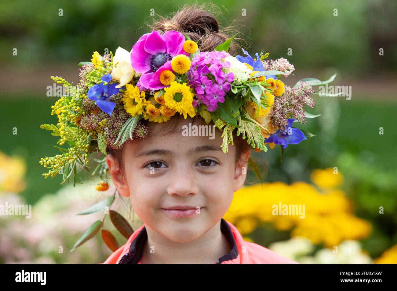 London, UK, 9 May 2021: Emelia, age 5, makes a flower crown to ...
