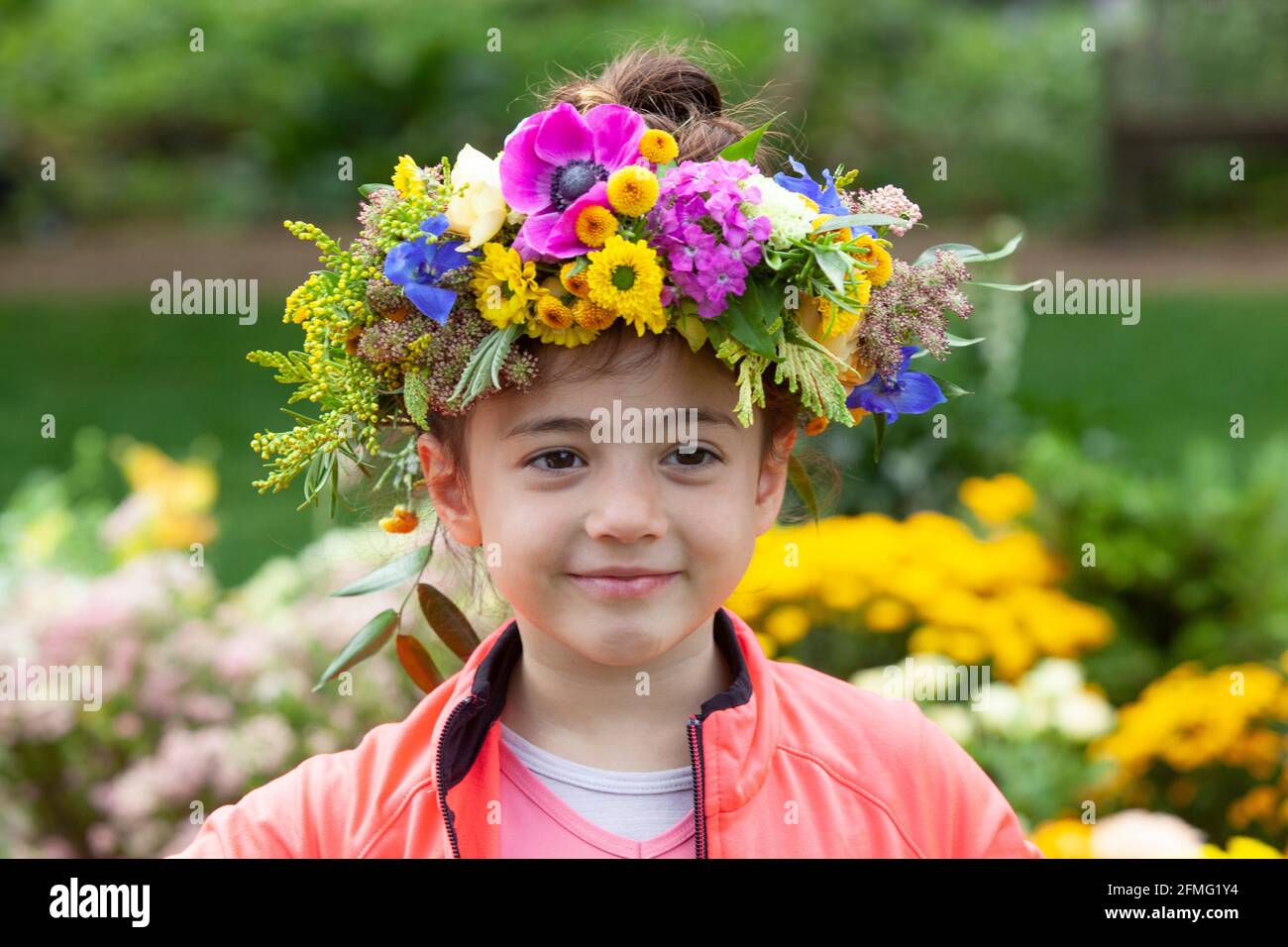 London, UK, 9 May 2021: Emelia, age 5, makes a flower crown to ...
