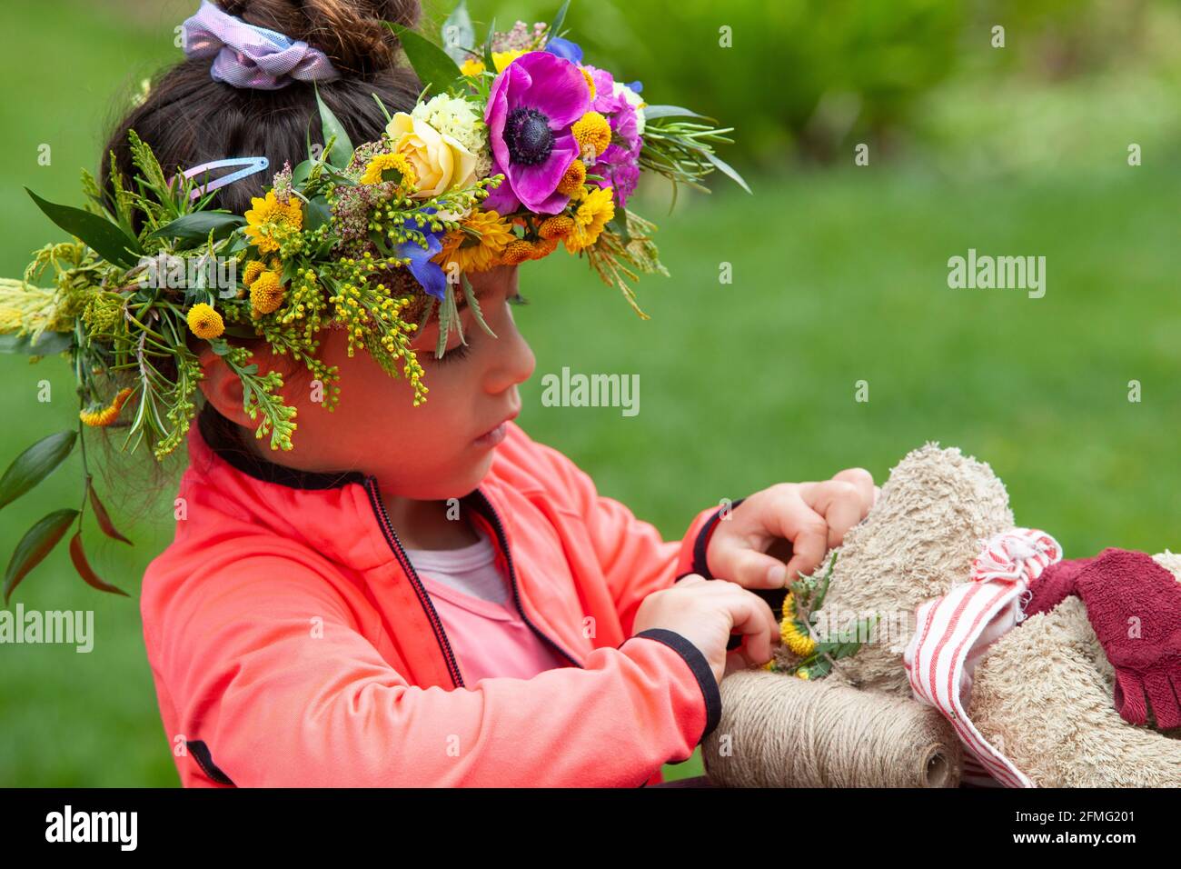 London, UK, 9 May 2021: Emelia, age 5, makes a flower crown to ...