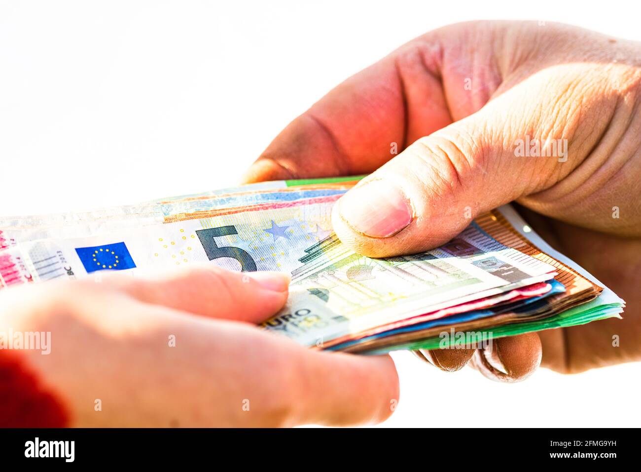 Hand giving stack of money isolated, hard worked hand taking euro money ...
