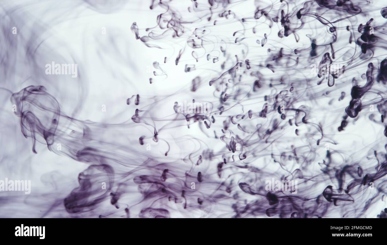 Photo about drops of purple ink falling in water Stock Photo - Alamy