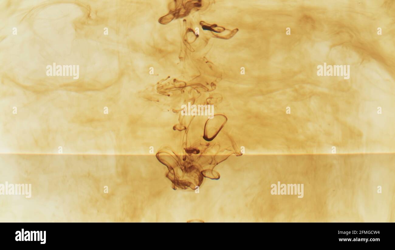 Photo of brown ink dissolving in liquid Stock Photo - Alamy