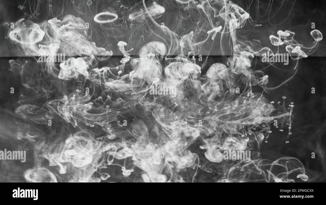 Image of the smoke dissolving in liquid Stock Photo - Alamy