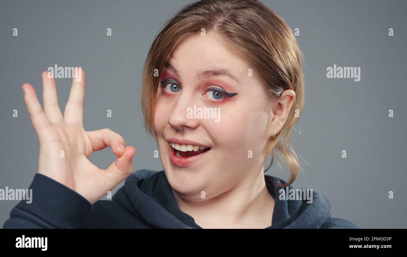 Photo of the stout woman with ok gesture, portrait Stock Photo - Alamy