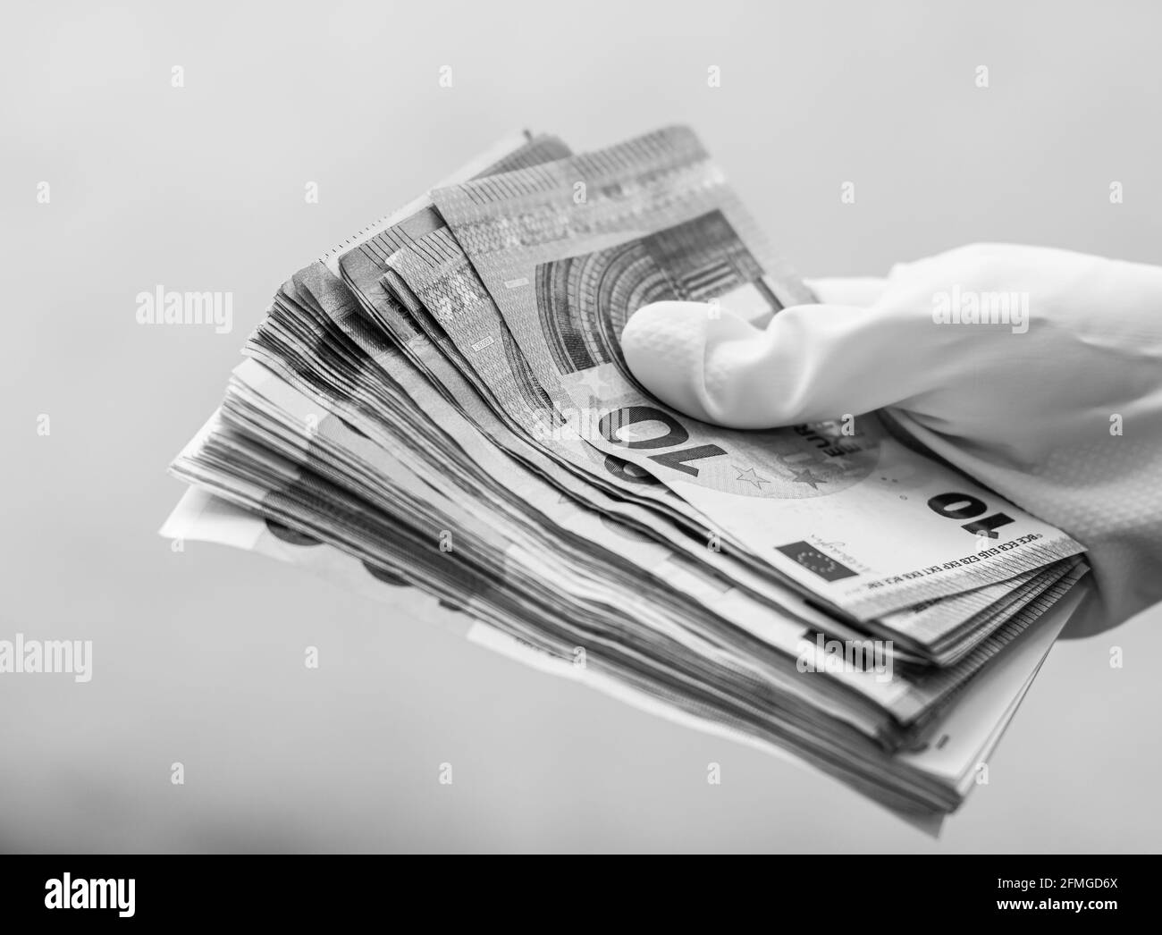 World money concept, hand with gloves receiving, giving or holding EURO ...