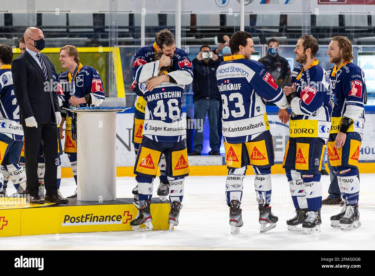 Raphael Diaz # 16 (EV Zug) hugs Lino Martschini # 46 (EV Zug) during ...