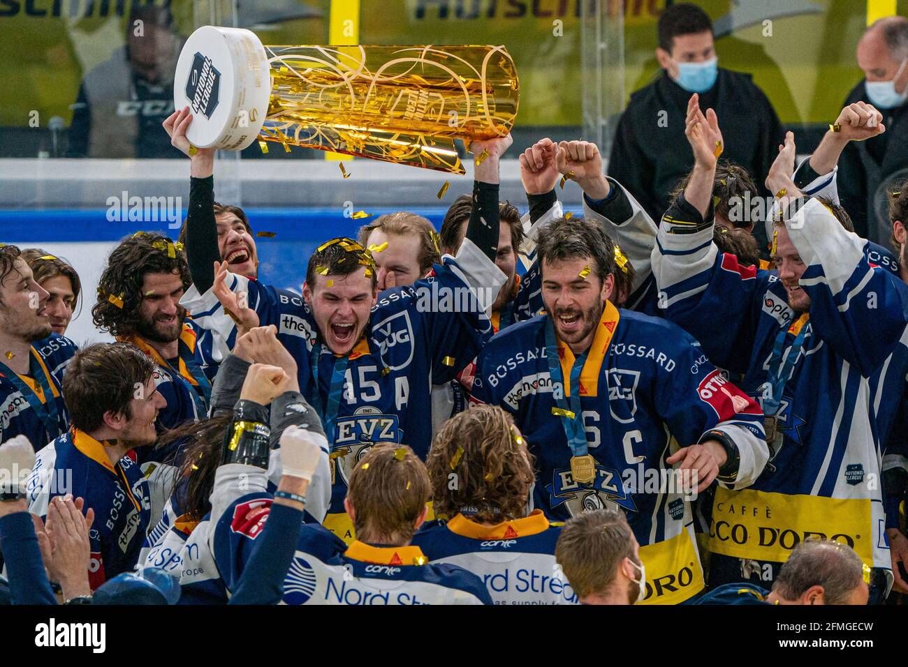 Gregory Hofmann # 15 (EV Zug) lifts the championship trophy during the ...
