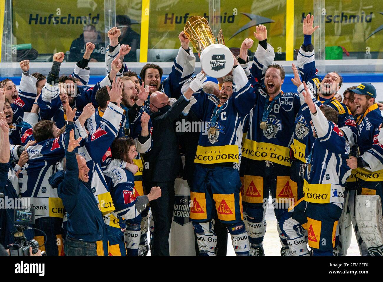 Raphael Diaz # 16 (EV Zug) lifts the trophy during the National League ...
