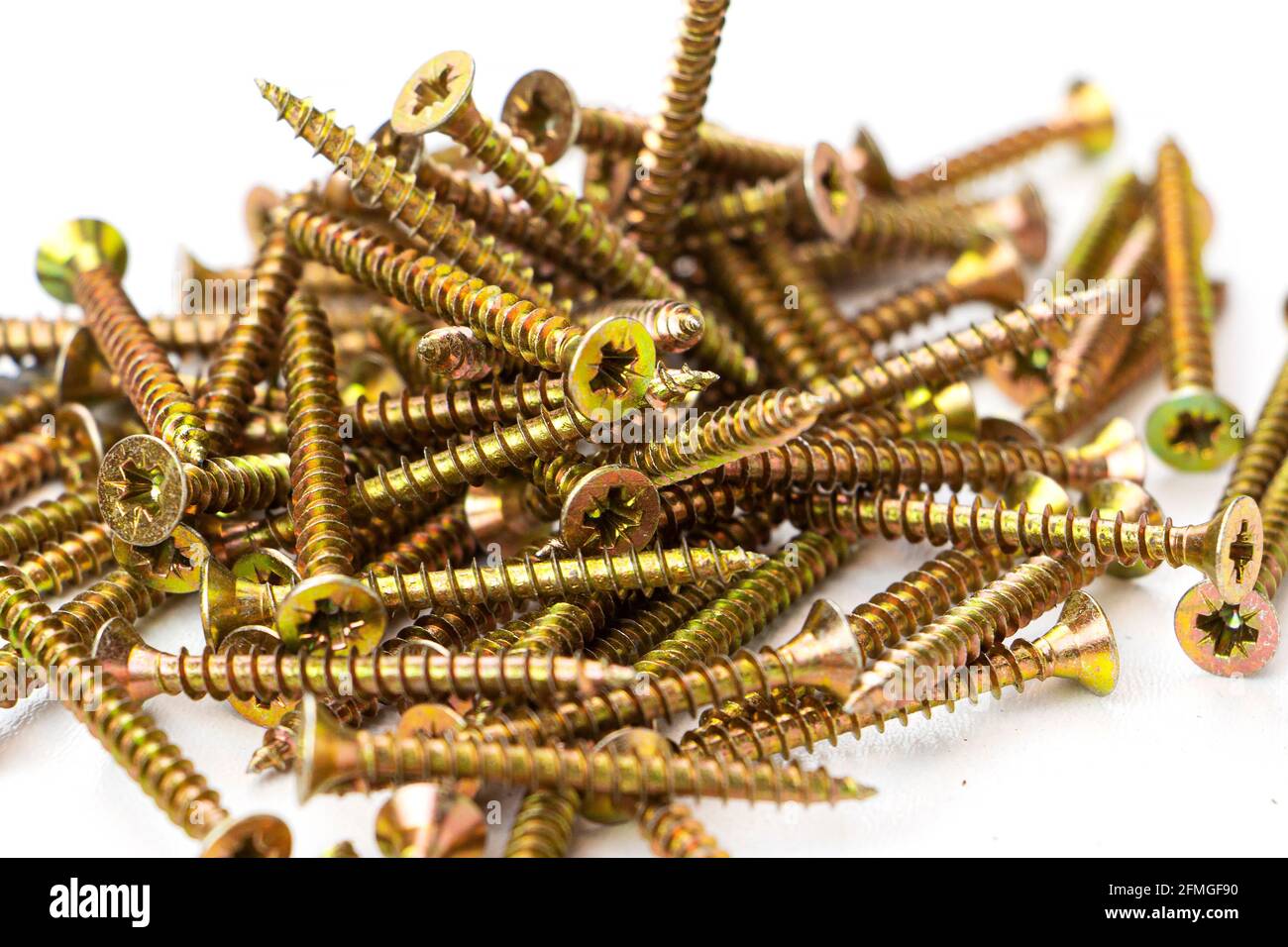 yellow self-tapping screw on a white background. A large number of ...