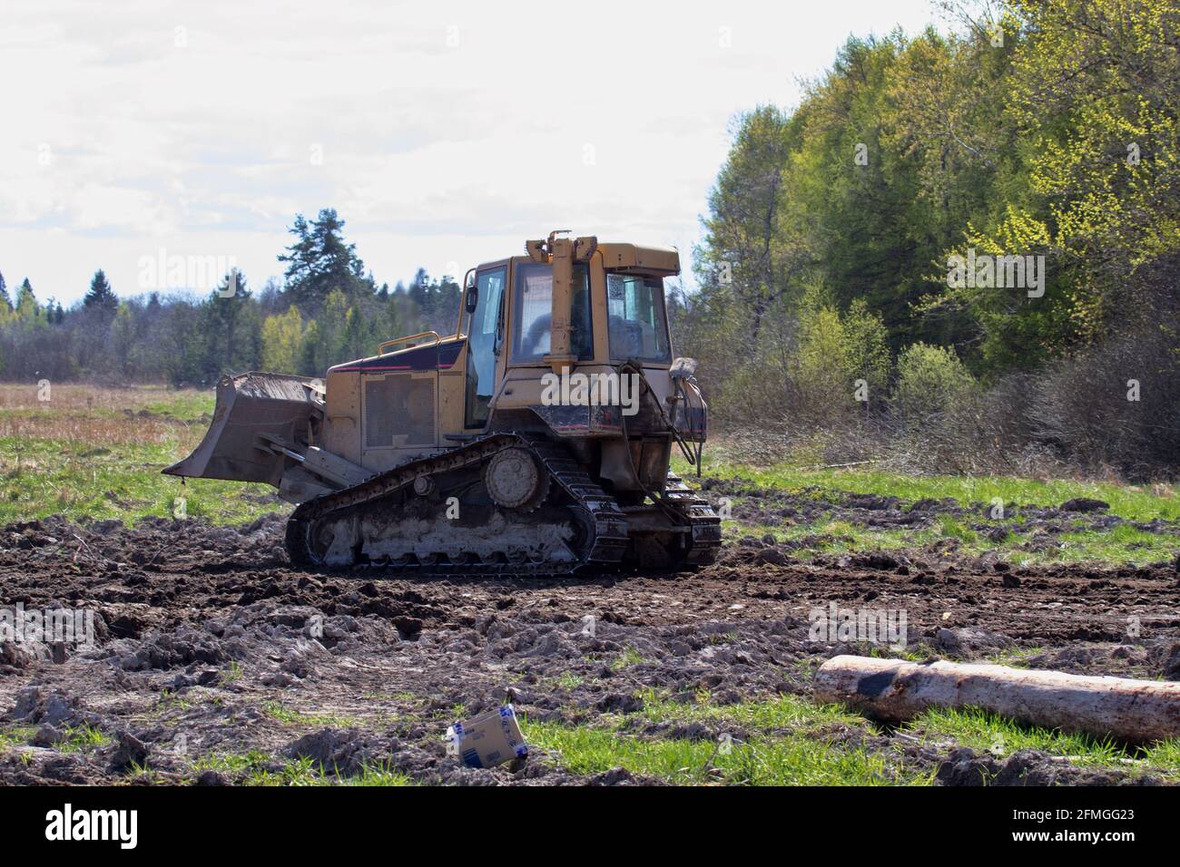 Bulldozer at work. Planning of the area, levelling of the site for ...