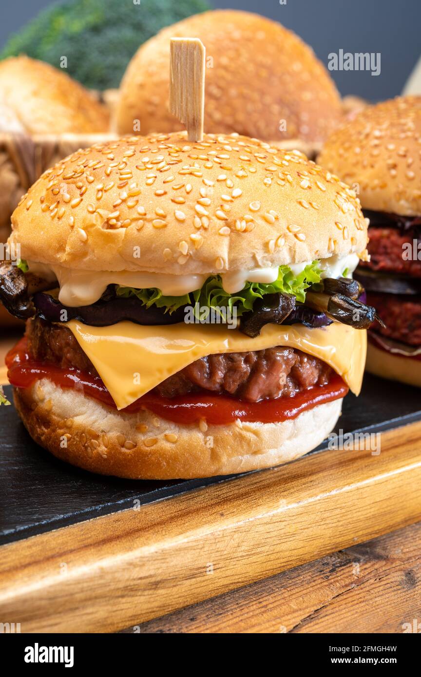 Tasty vegetarian cheeseburgers and hamburgers with round patties or ...