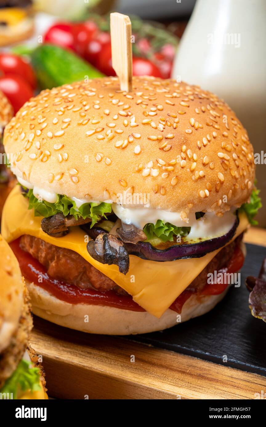 Tasty vegetarian cheeseburgers and hamburgers with round patties or ...