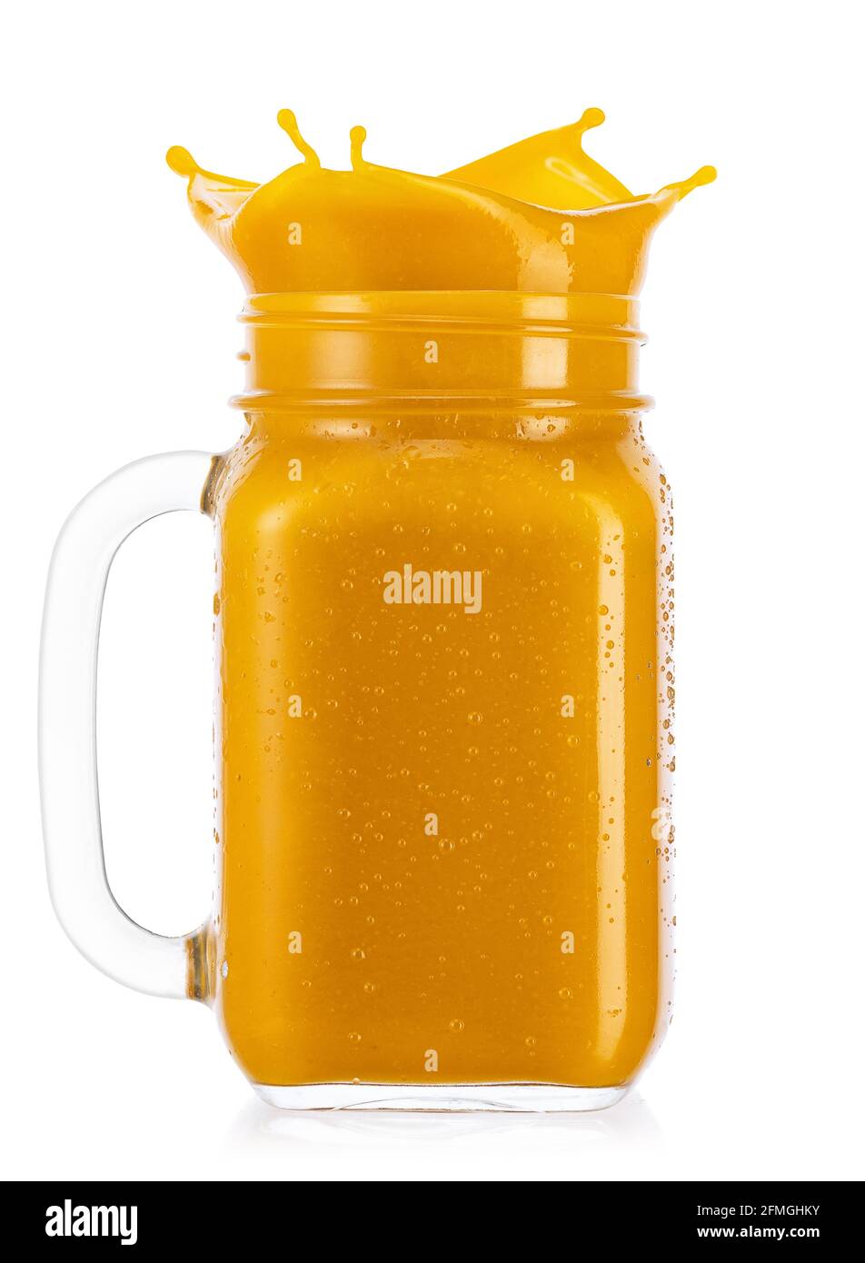 mason jar of splashing mango smoothies isolated on white Stock Photo ...