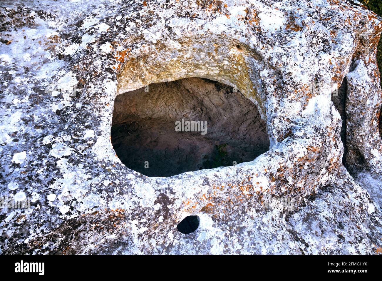Entrance to a man-made cave in a limestone rock. A place of refuge for ...