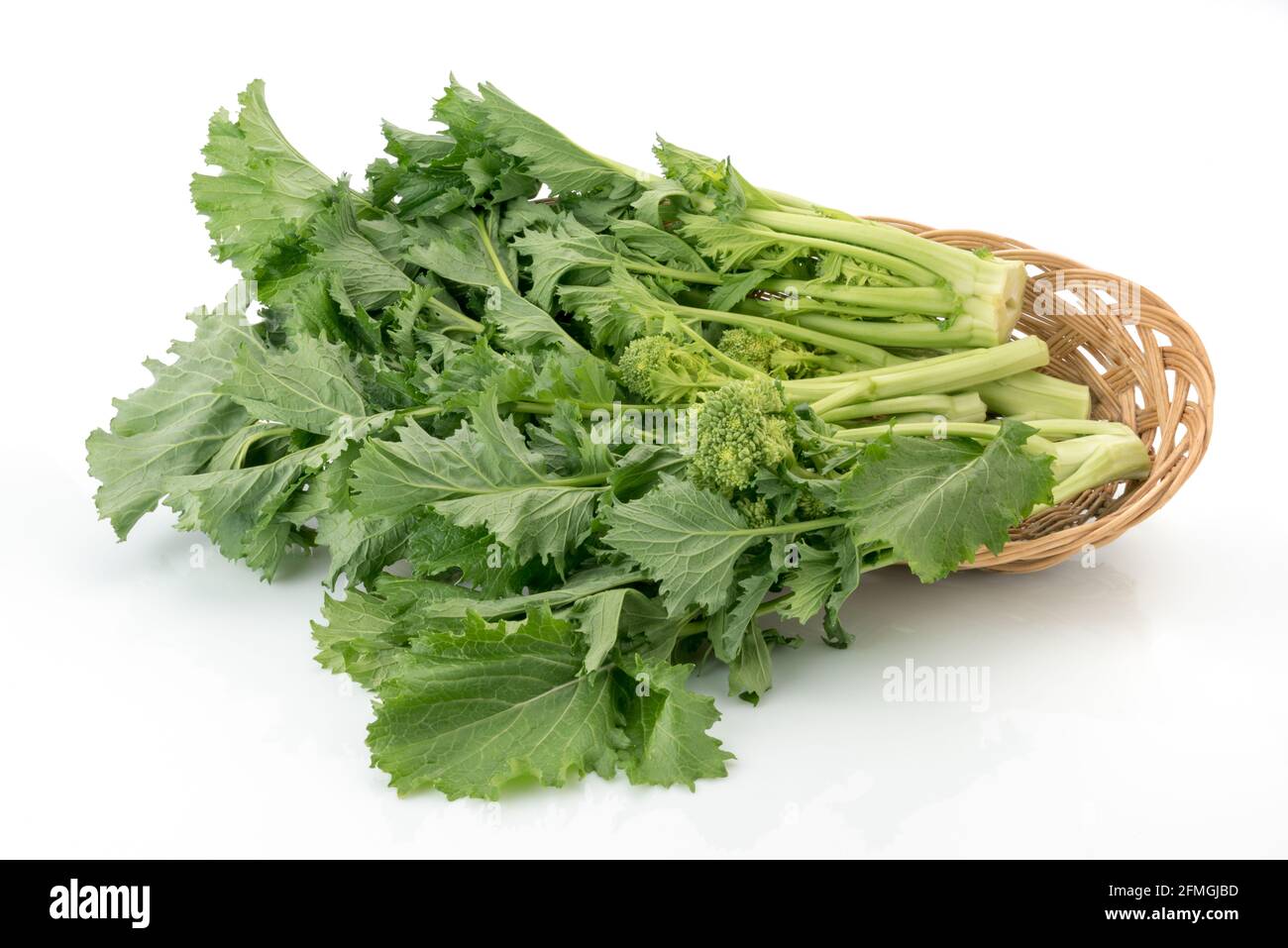Fresh turnip tops in wicker basket, italian cime di rapa, isolated on ...