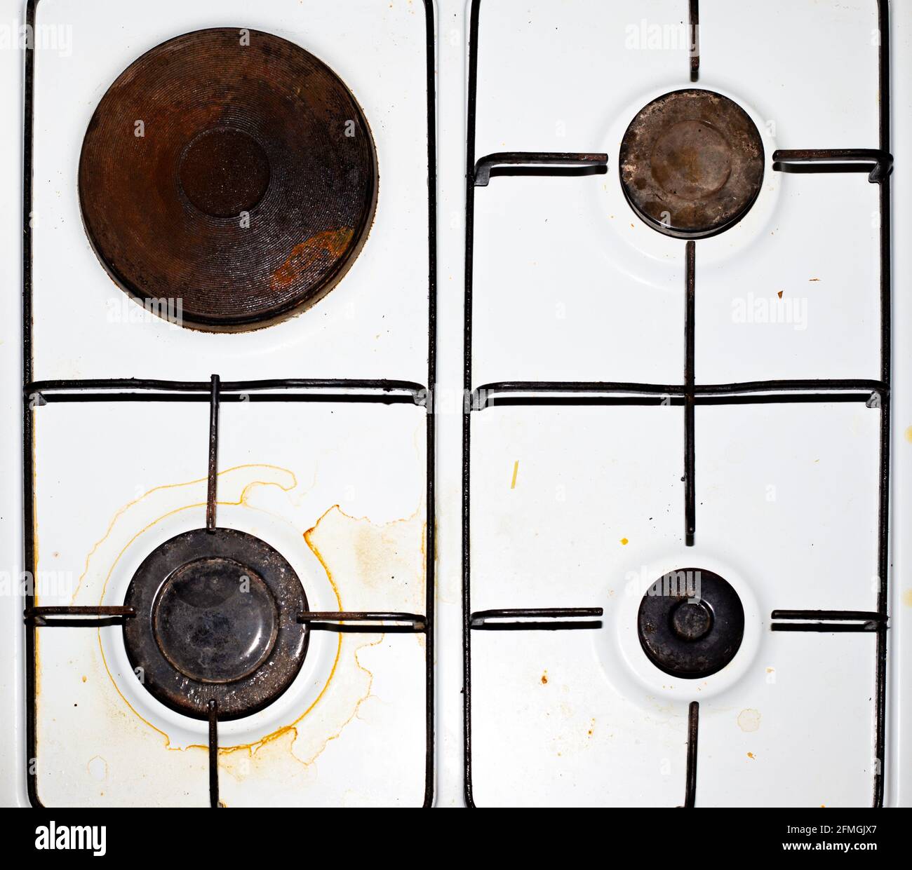 Dirty metal plate. The burners of the electric and gas combination hob ...