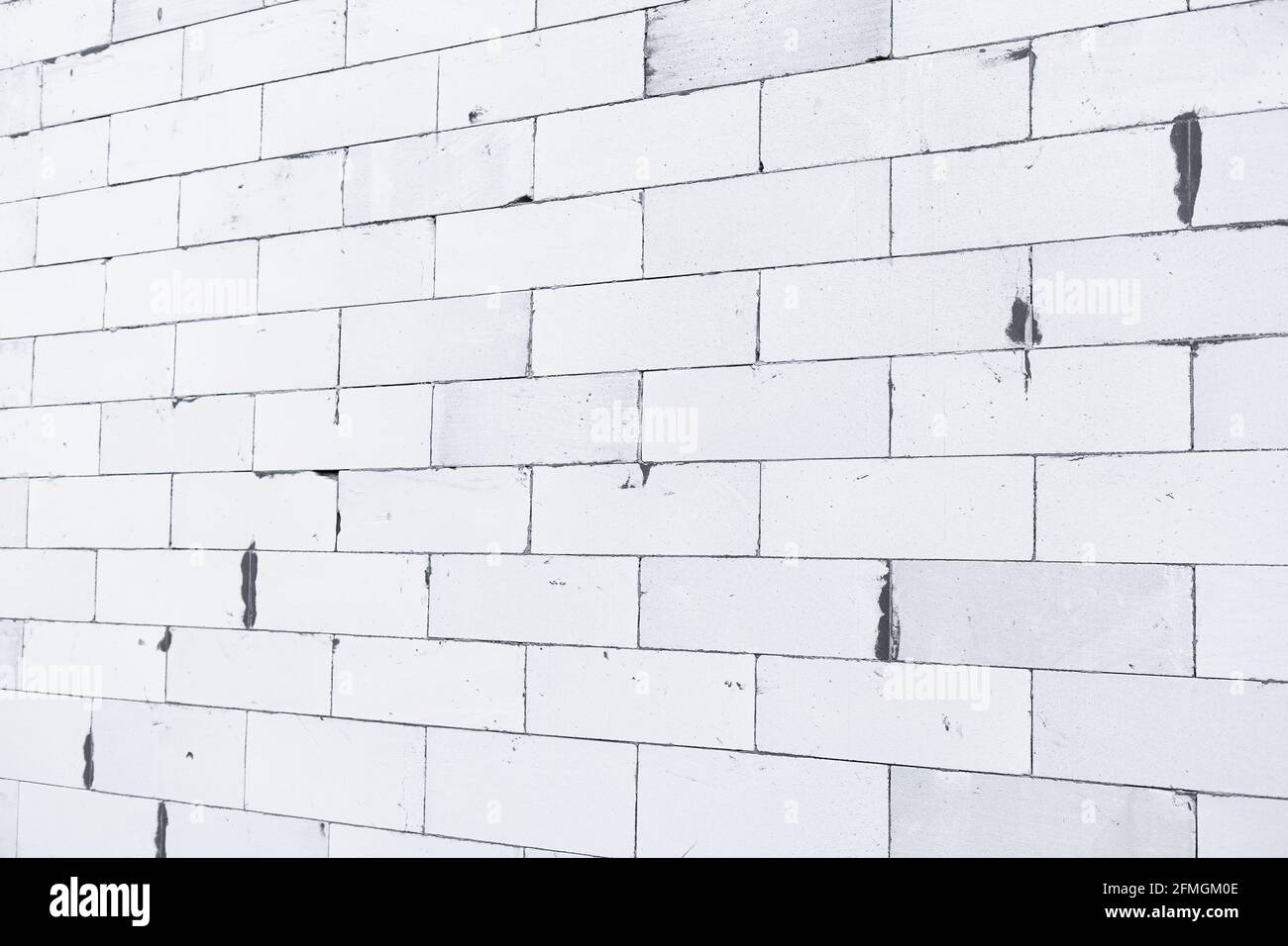 The wall is built of white aerated concrete. The background is made of ...