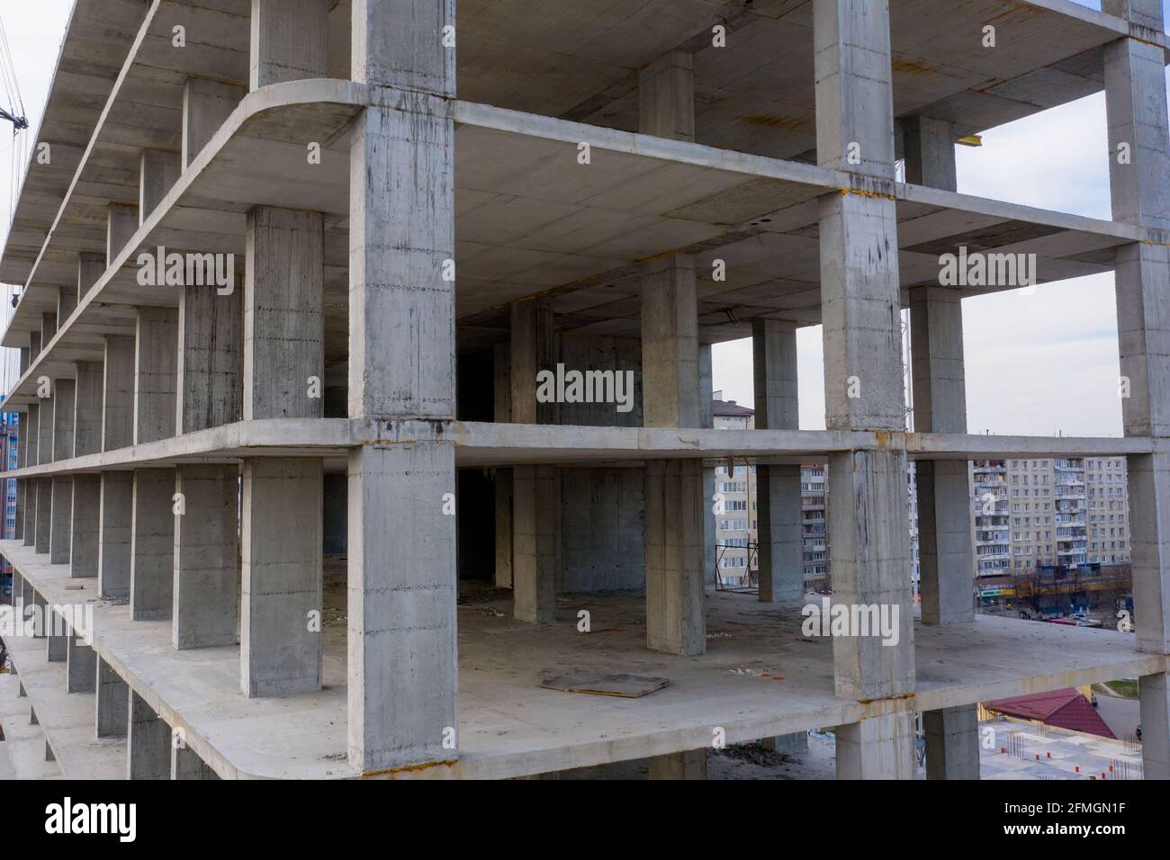 Aerial view of concrete frame of tall apartment building under ...