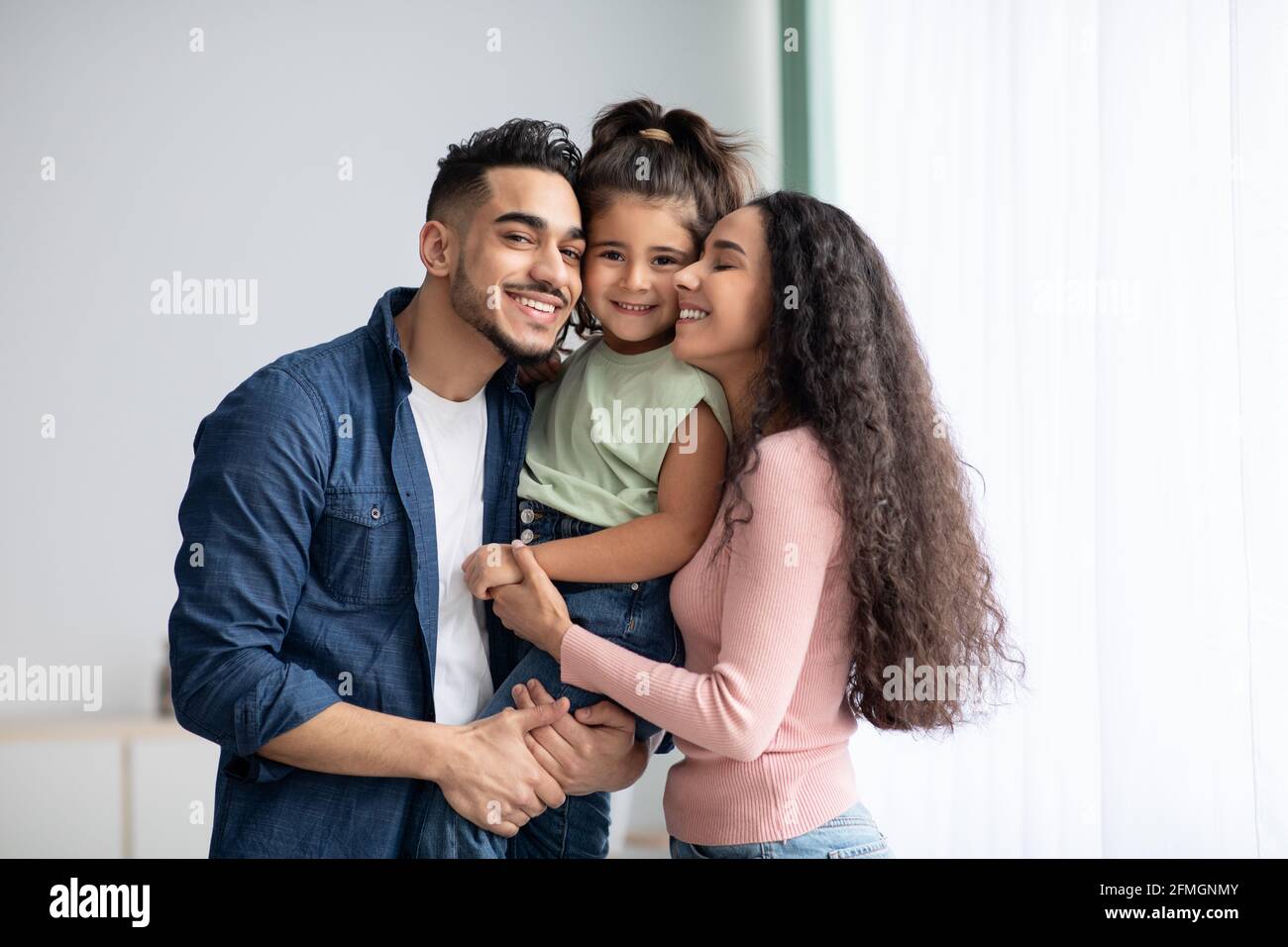 Happy Arab Parents And Their Little Daughter Bonding At Home Stock ...