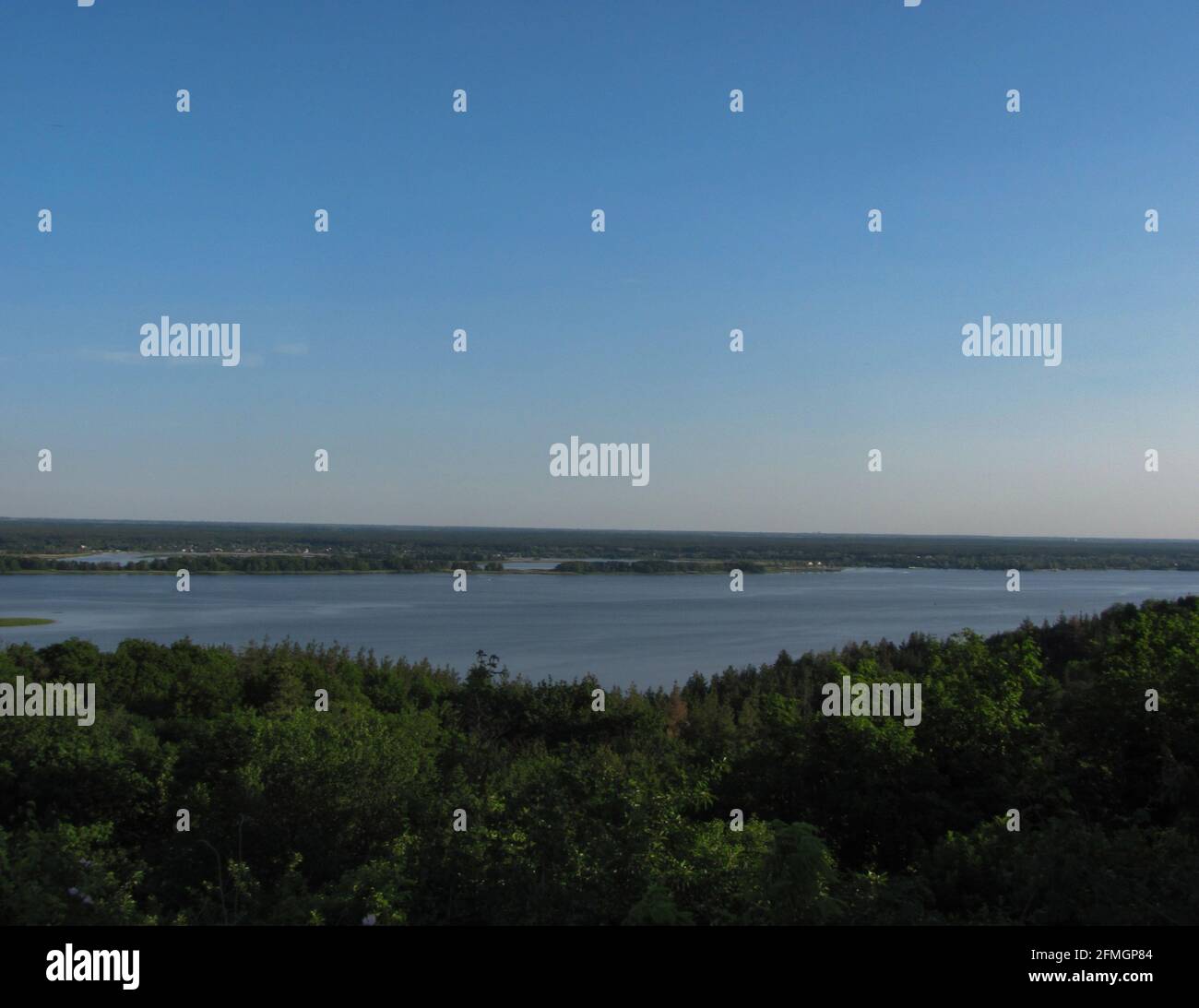 landscape background: green forest, river with islands and blue sky ...