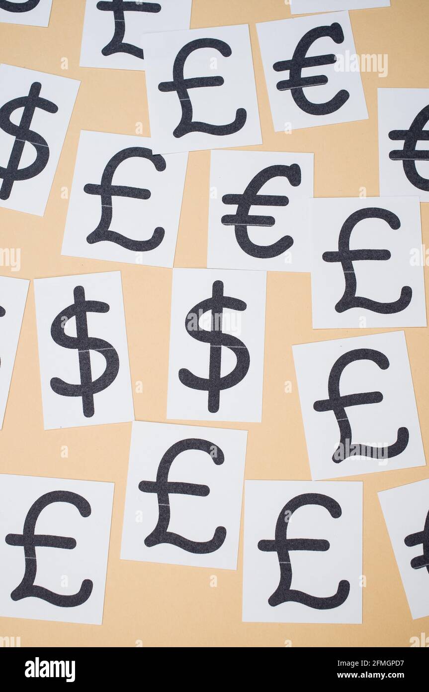 A vertical shot of white sticky notes with currency signs on pastel ...