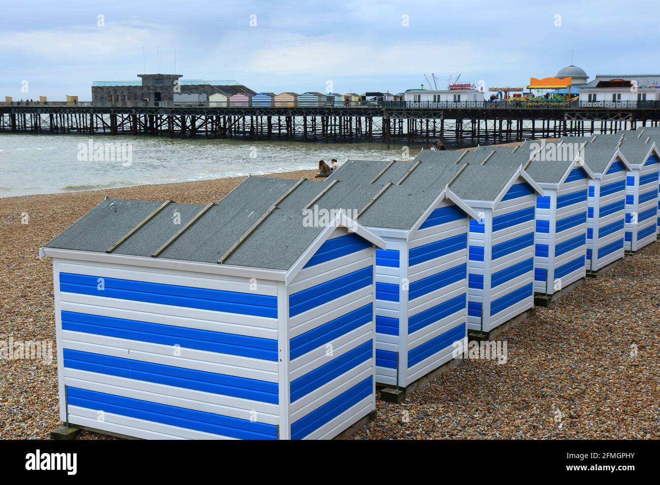 Beach huts overlooking the pier at Hastings Stock Photo - Alamy