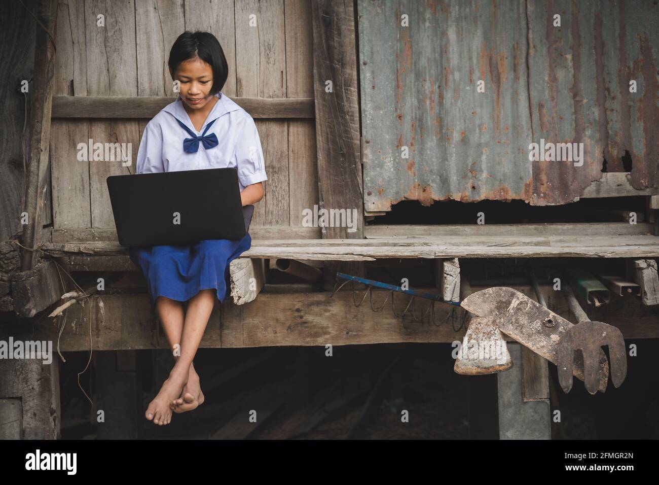 Asian uniform student girl using computer laptop during the lock-down ...