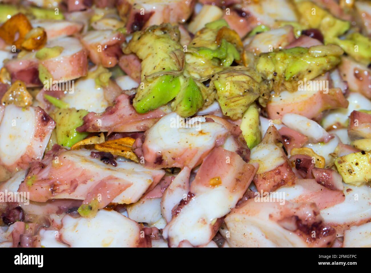 Octopus peaces with avocado Stock Photo - Alamy