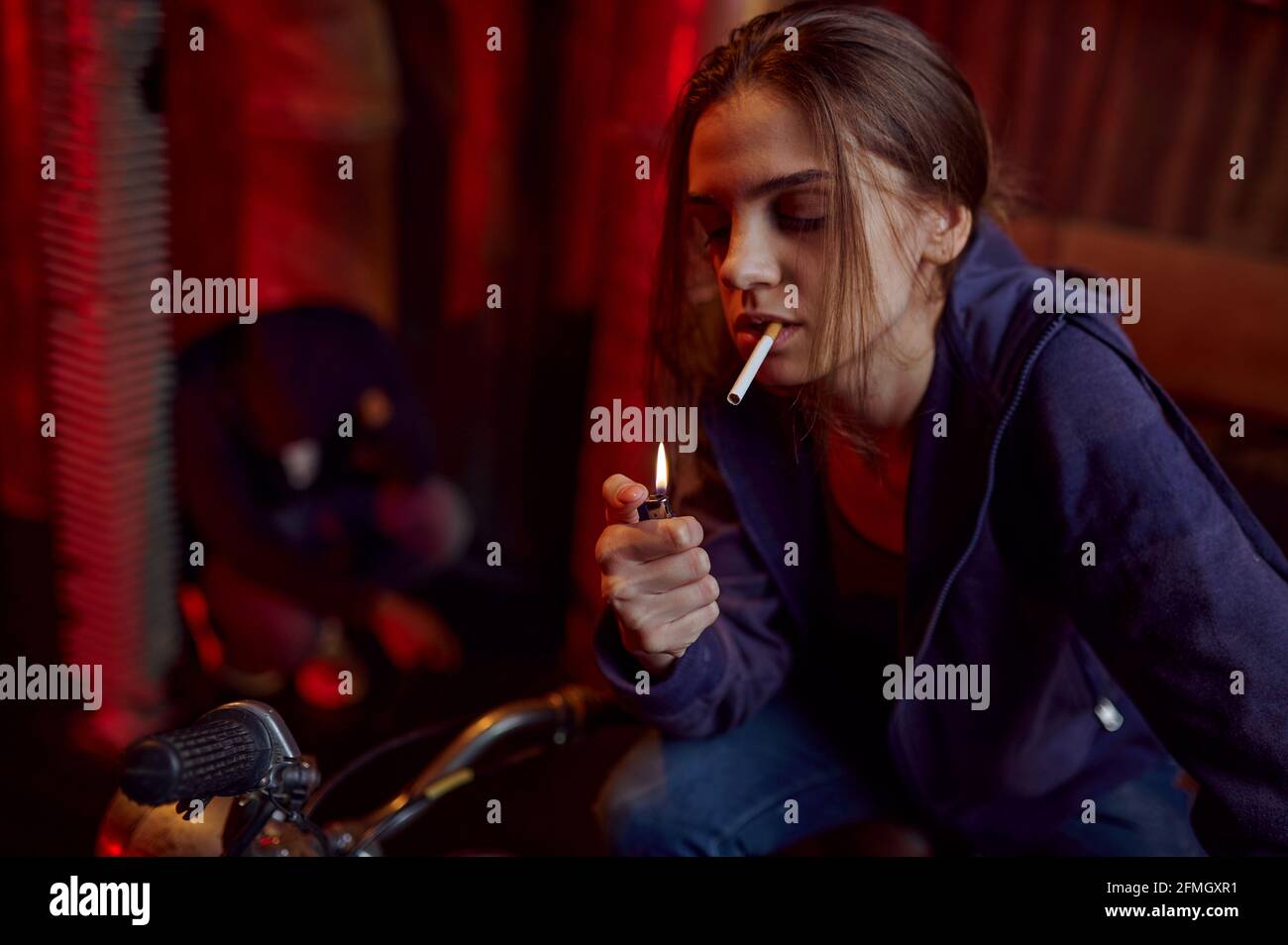 Drug addict woman smokes a cigarette Stock Photo - Alamy