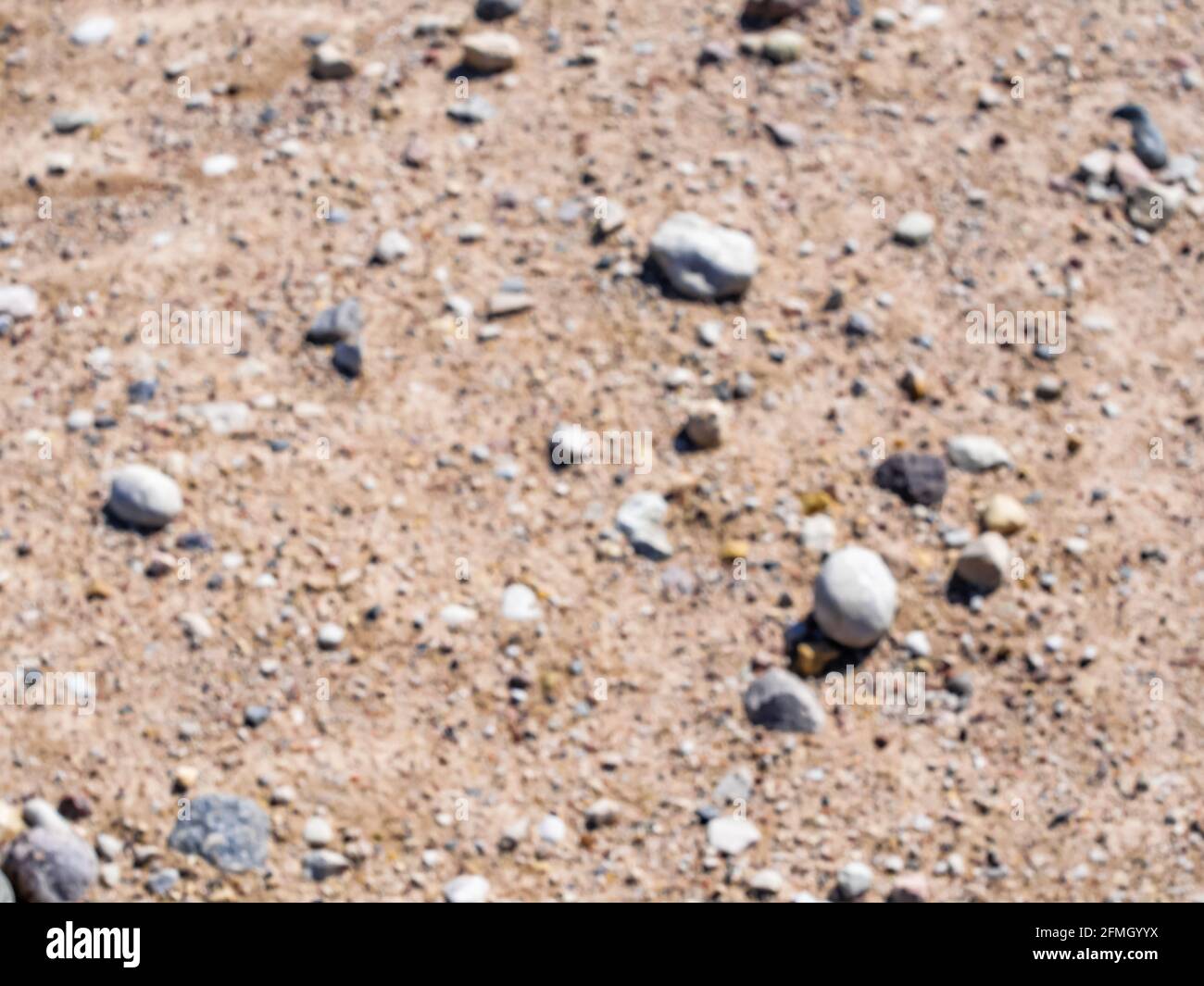 A blurred background with small pebble stones on a dirty ground Stock ...