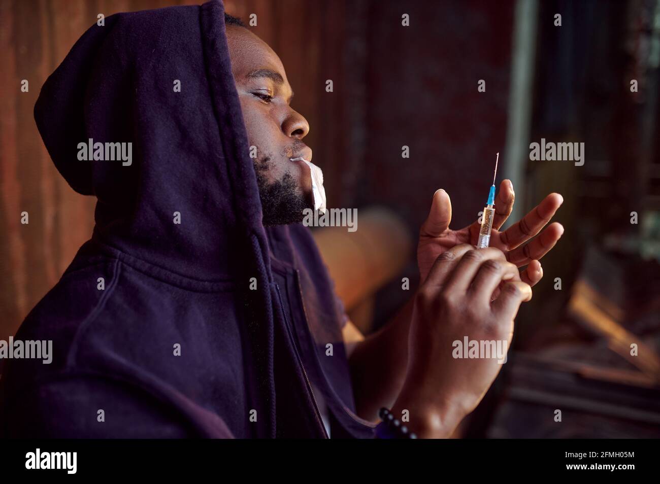 Addict prepares syringe hi-res stock photography and images - Alamy