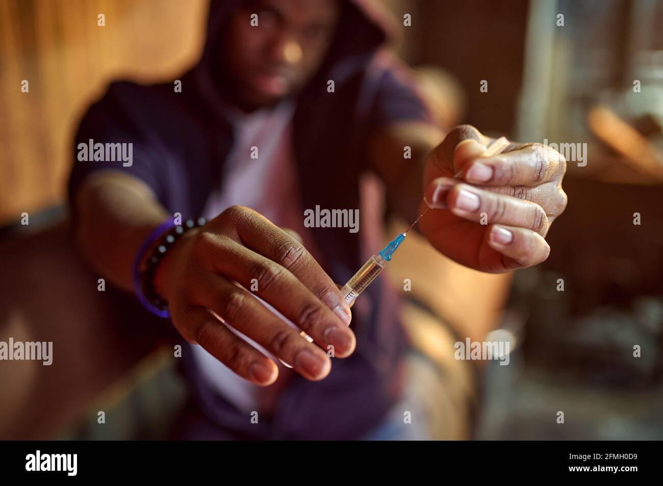 Drug addict man holds syringe with dose Stock Photo - Alamy