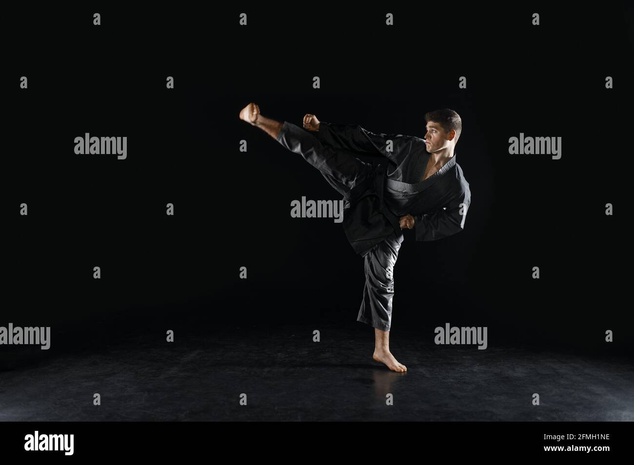 Male karateka, fighter in black kimono, training Stock Photo - Alamy