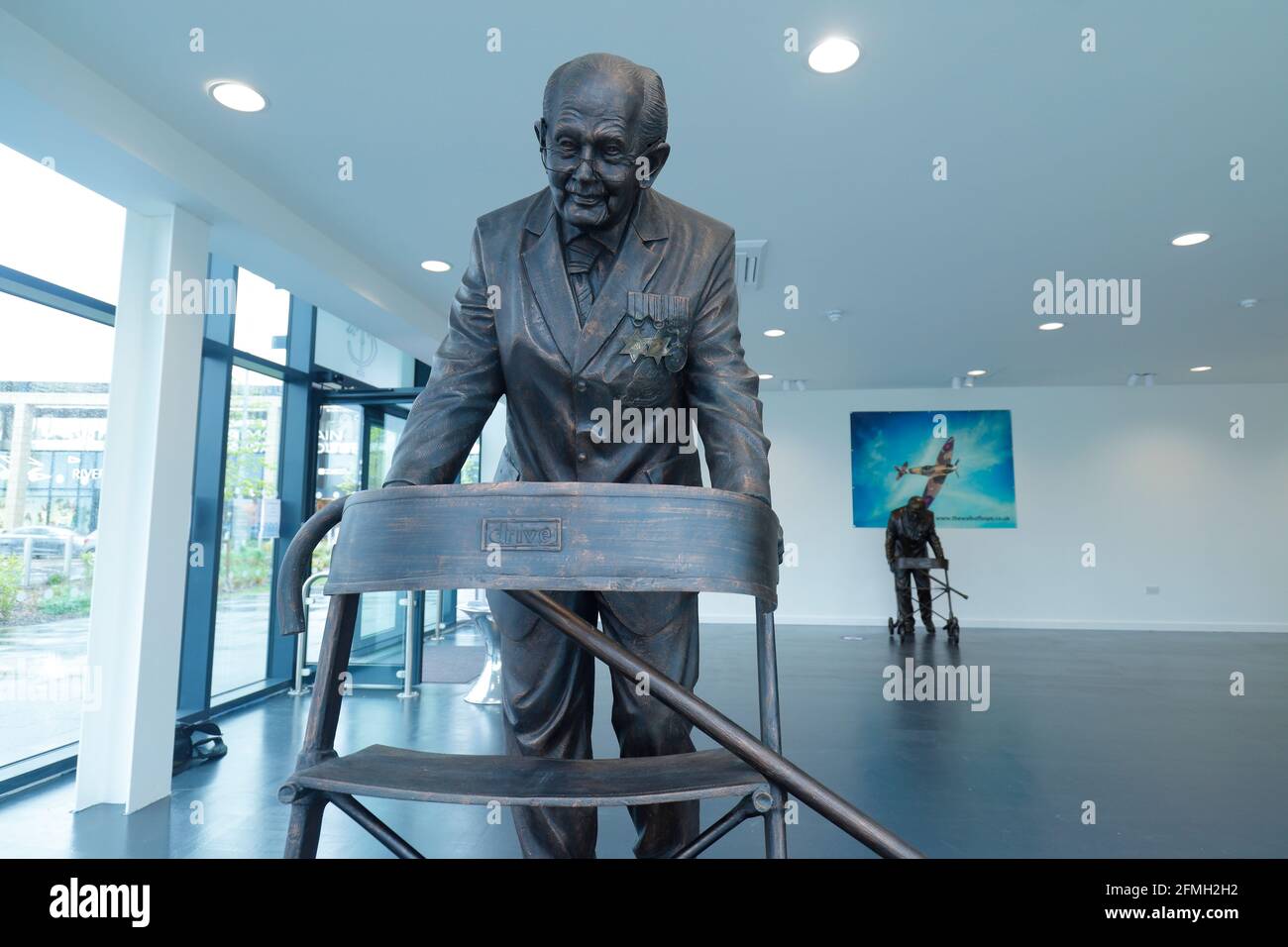 A resin and bronze statue of the late Sir Captain Tom Moore on display ...