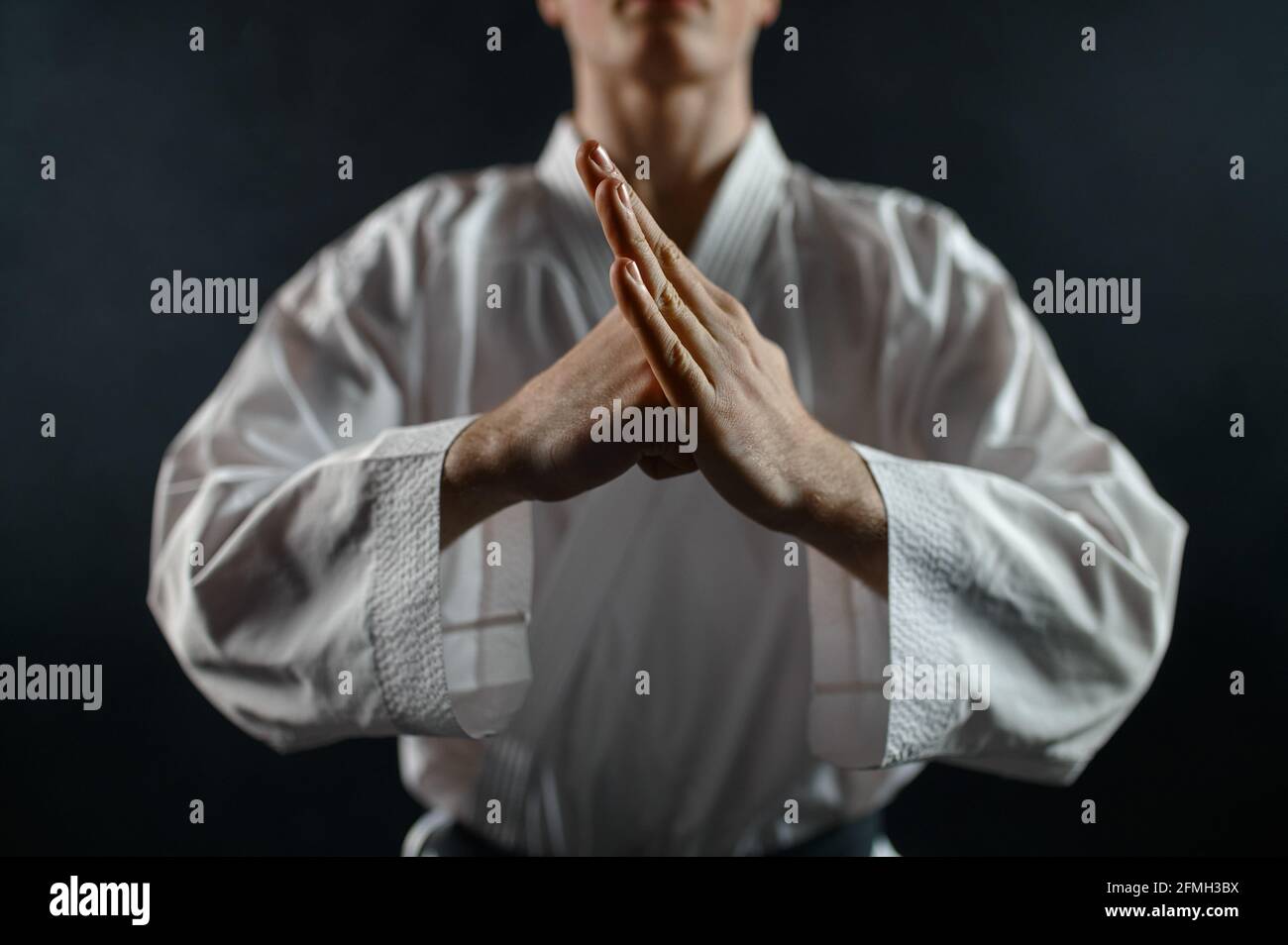Male karate fighter in white kimono, welcome sign Stock Photo - Alamy